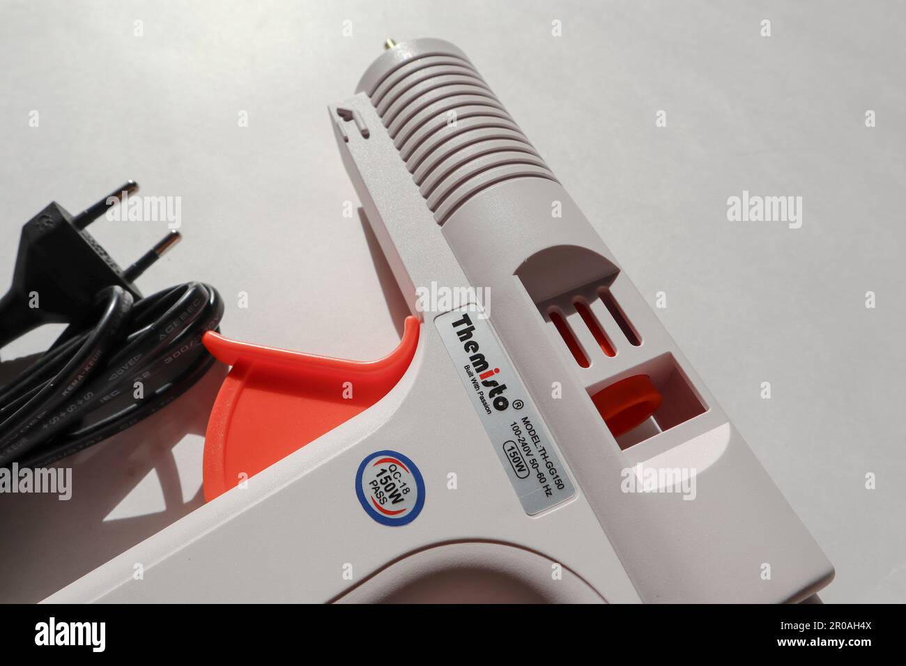 Hot Glue gun in white color with electric cord on white background ...