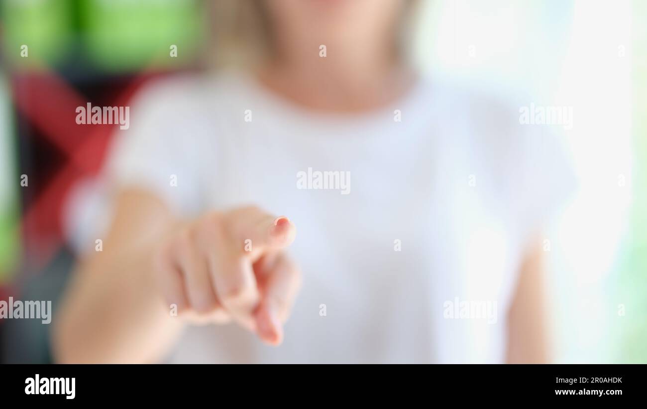Woman hand pointing at camera with finger, advertising or promotion ...