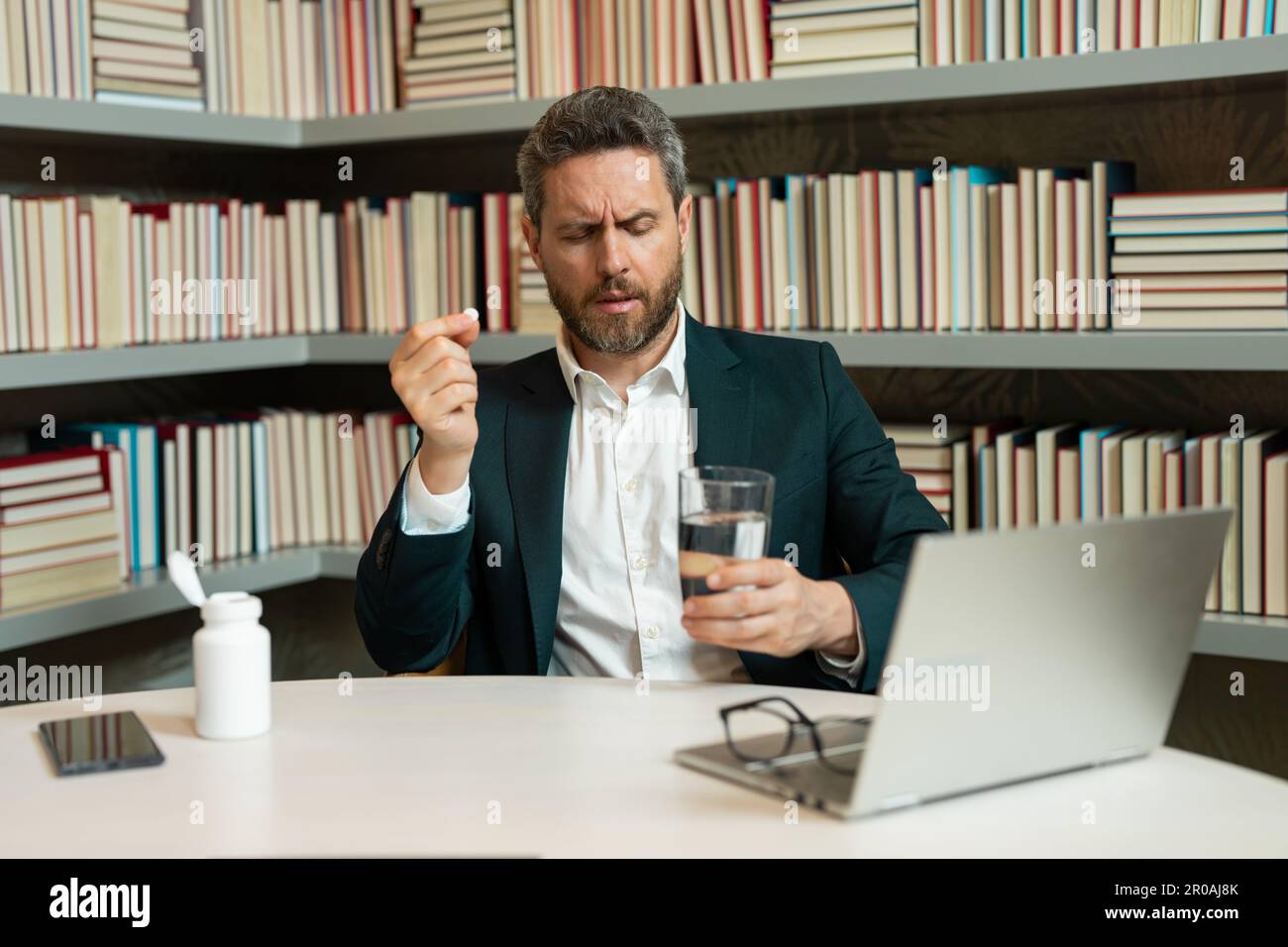 Headache and eye strain on laptop. Business man with stress and fatigue ...