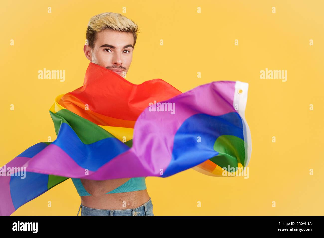 Happy gay man waving a lgbt rainbow flag Stock Photo - Alamy