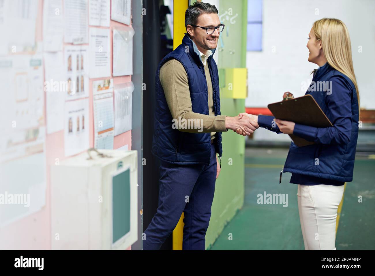 Youre doing a great job around here. two managers shaking hands ...