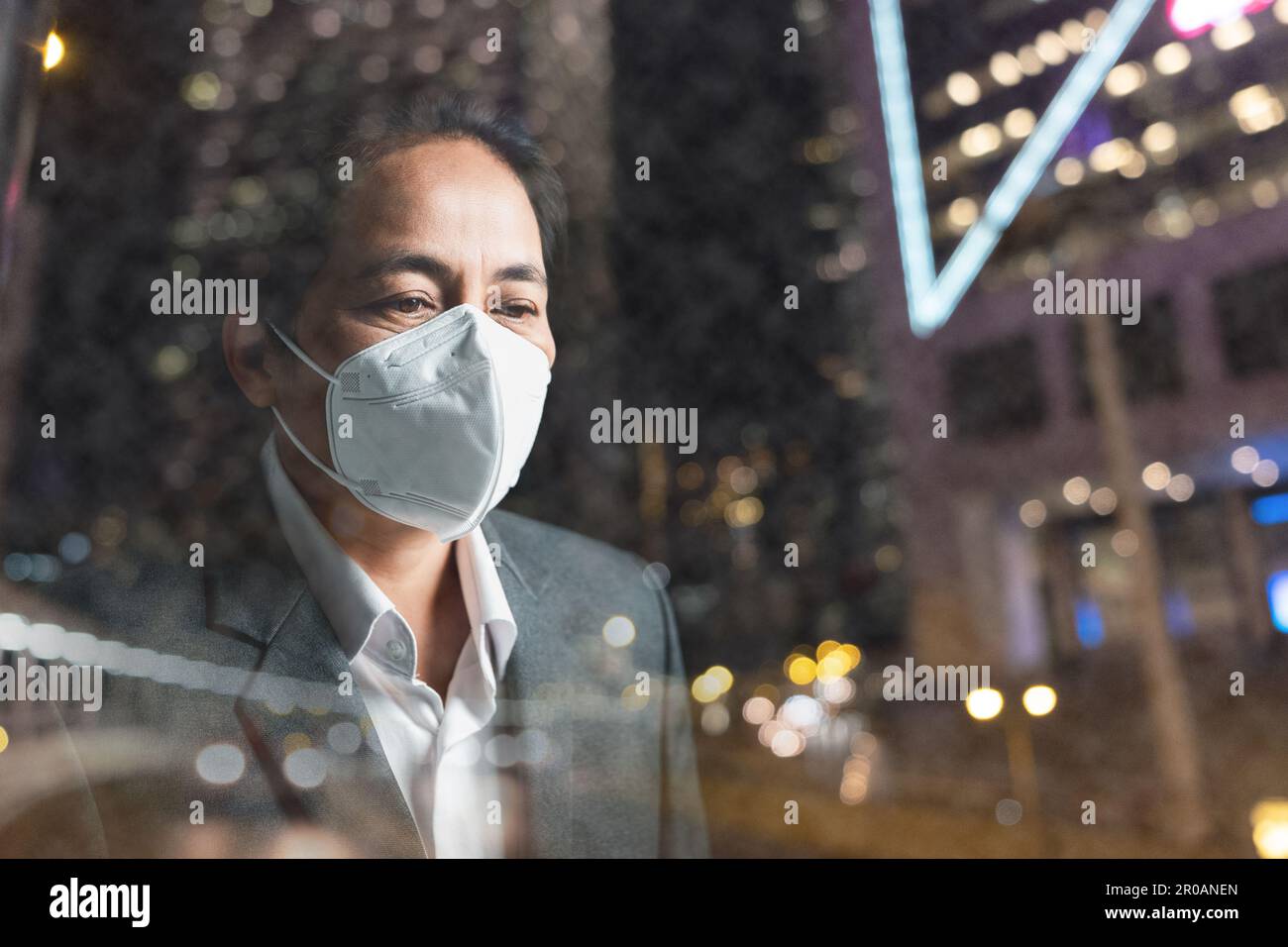 Woman wearing N95 PM 2.5 respiratory protection mask against air ...