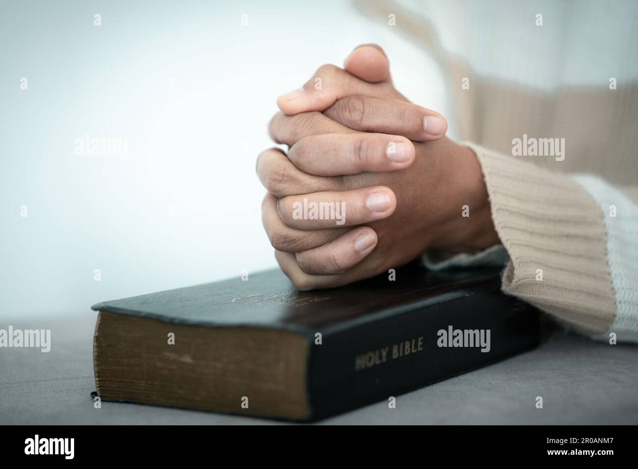 woman kneeling and praying in modern house at sunset time. Female ...