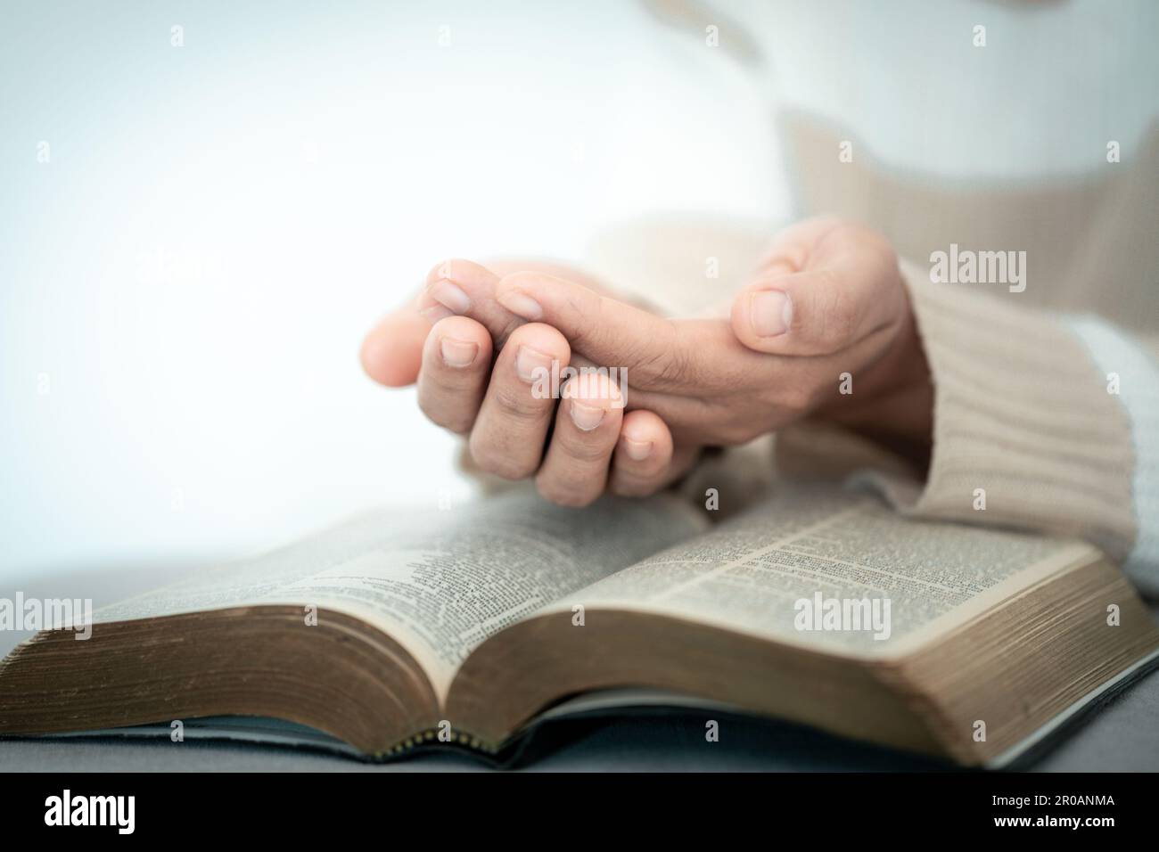 woman kneeling and praying in modern house at sunset time. Female ...