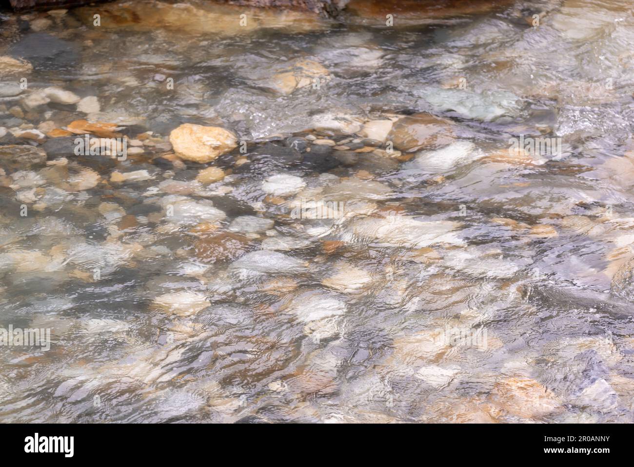 A shallow river bed seen in spring time with clear, pristine water ...