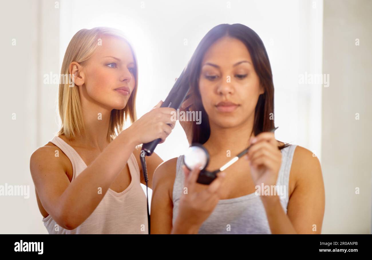 Best friends help each other to look their best. a young woman applying ...