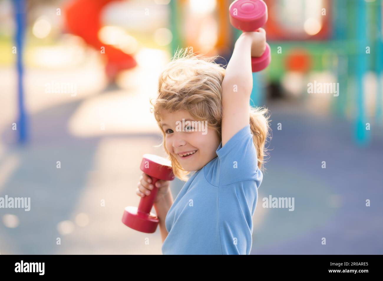 Kids sport training on playground outdoor. Child boy working out with ...