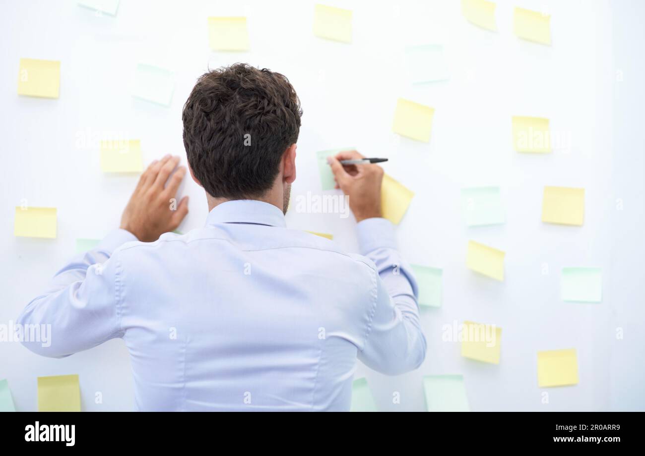 Coming up with a fantastic plan. Rearview shot of a young businessmen ...
