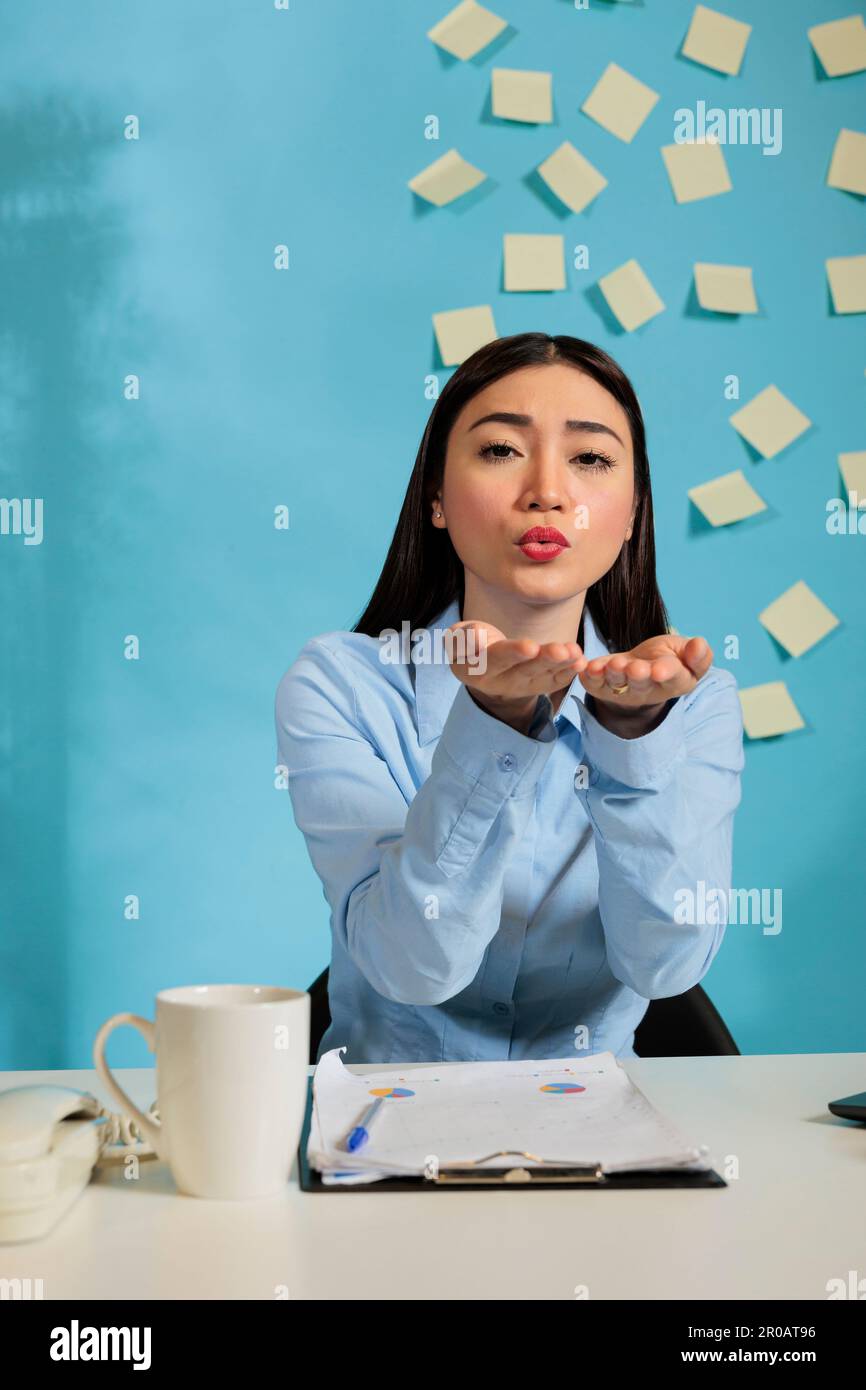 Asian professional woman showing positive feelings at work place ...