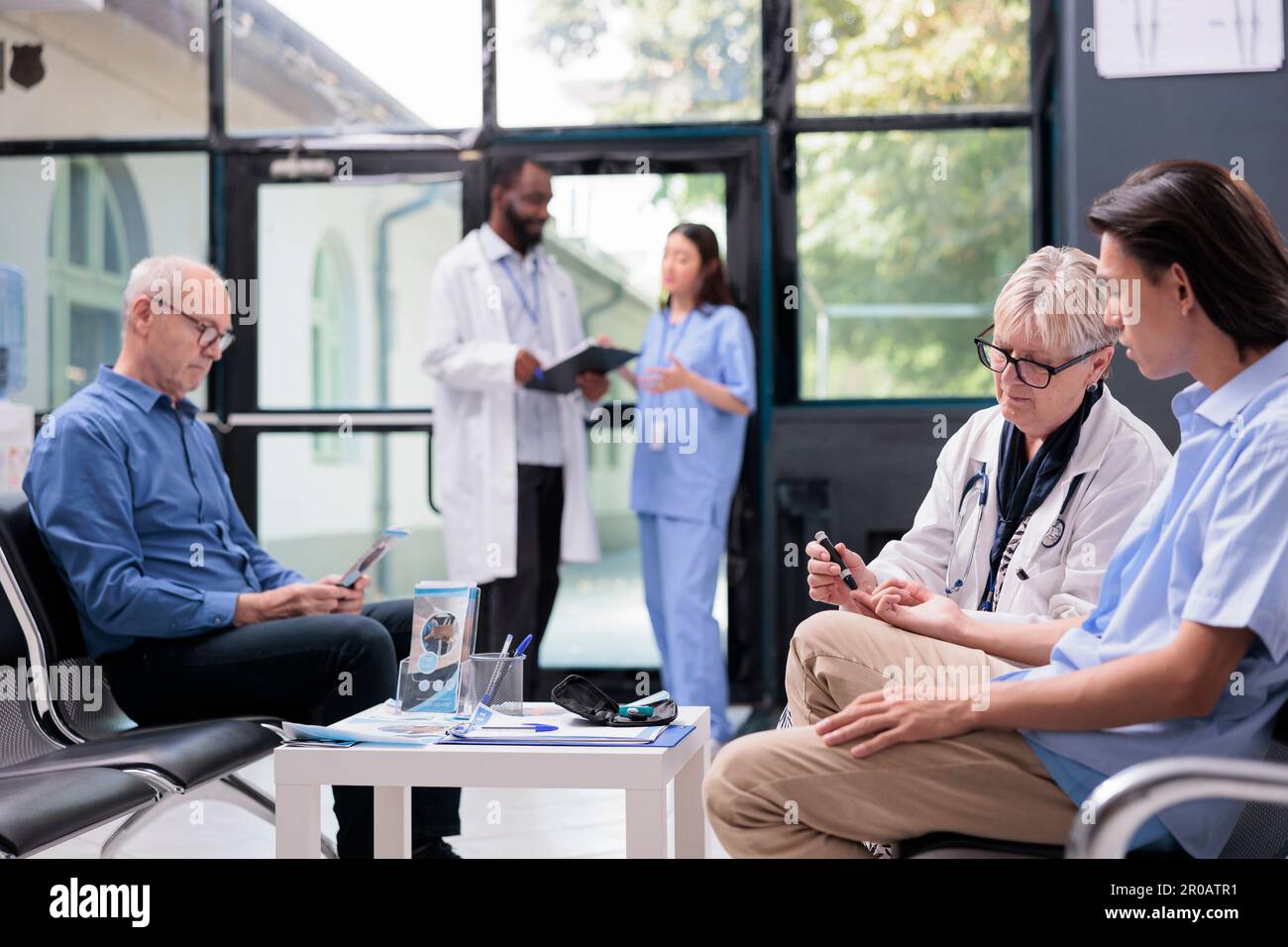 Elderly medic doing insulin level measurement with instrument to help ...