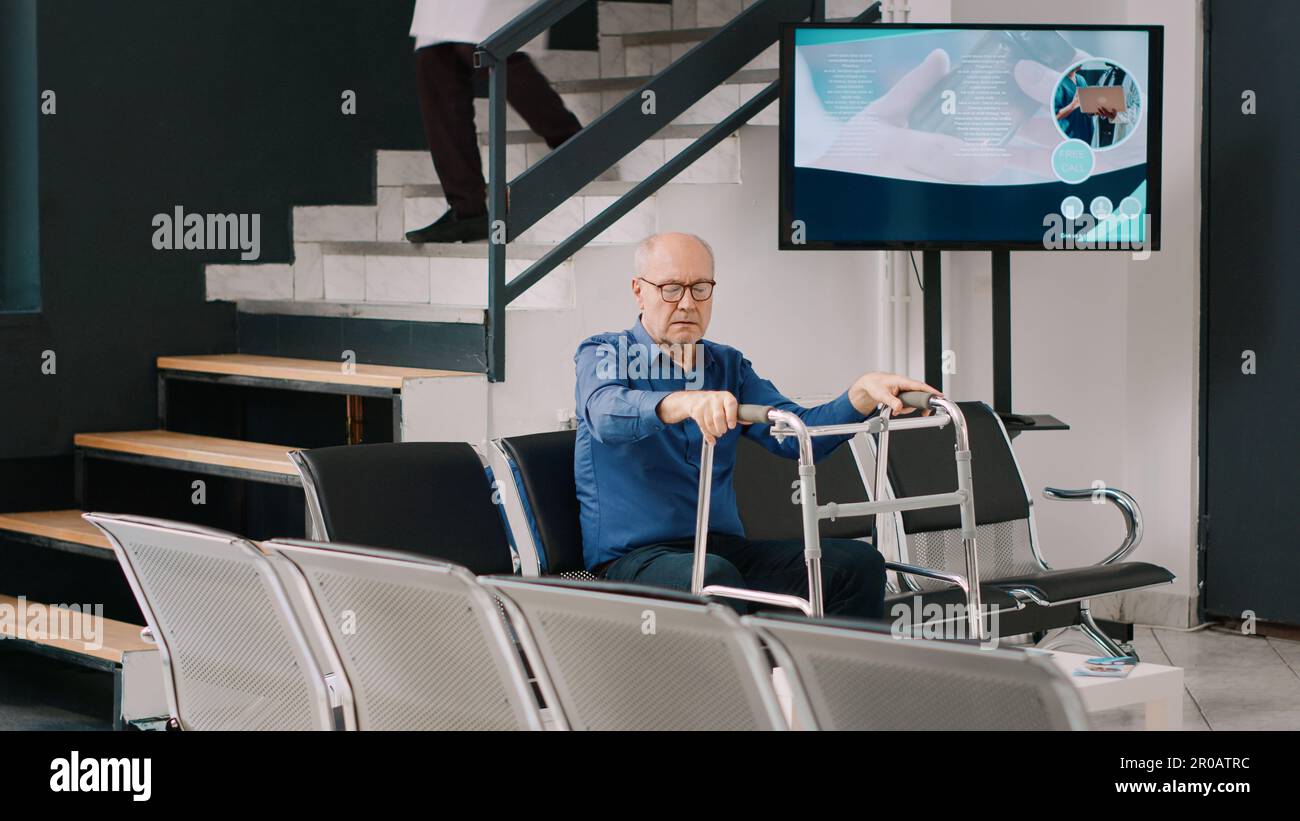 Elderly man and woman waiting in hospital lobby to attend checkup ...