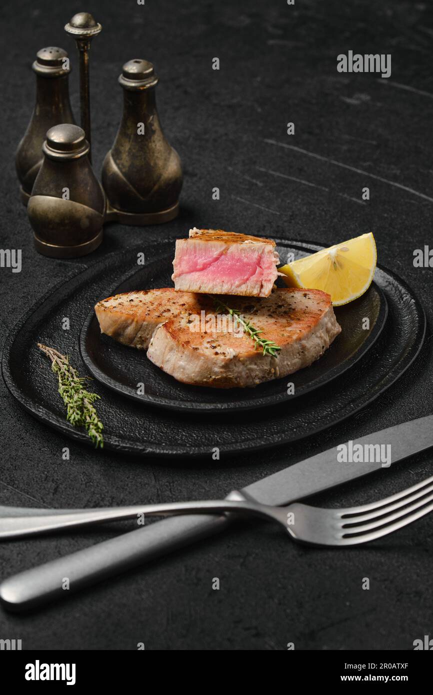 Fried tuna steak on a stone plate Stock Photo - Alamy