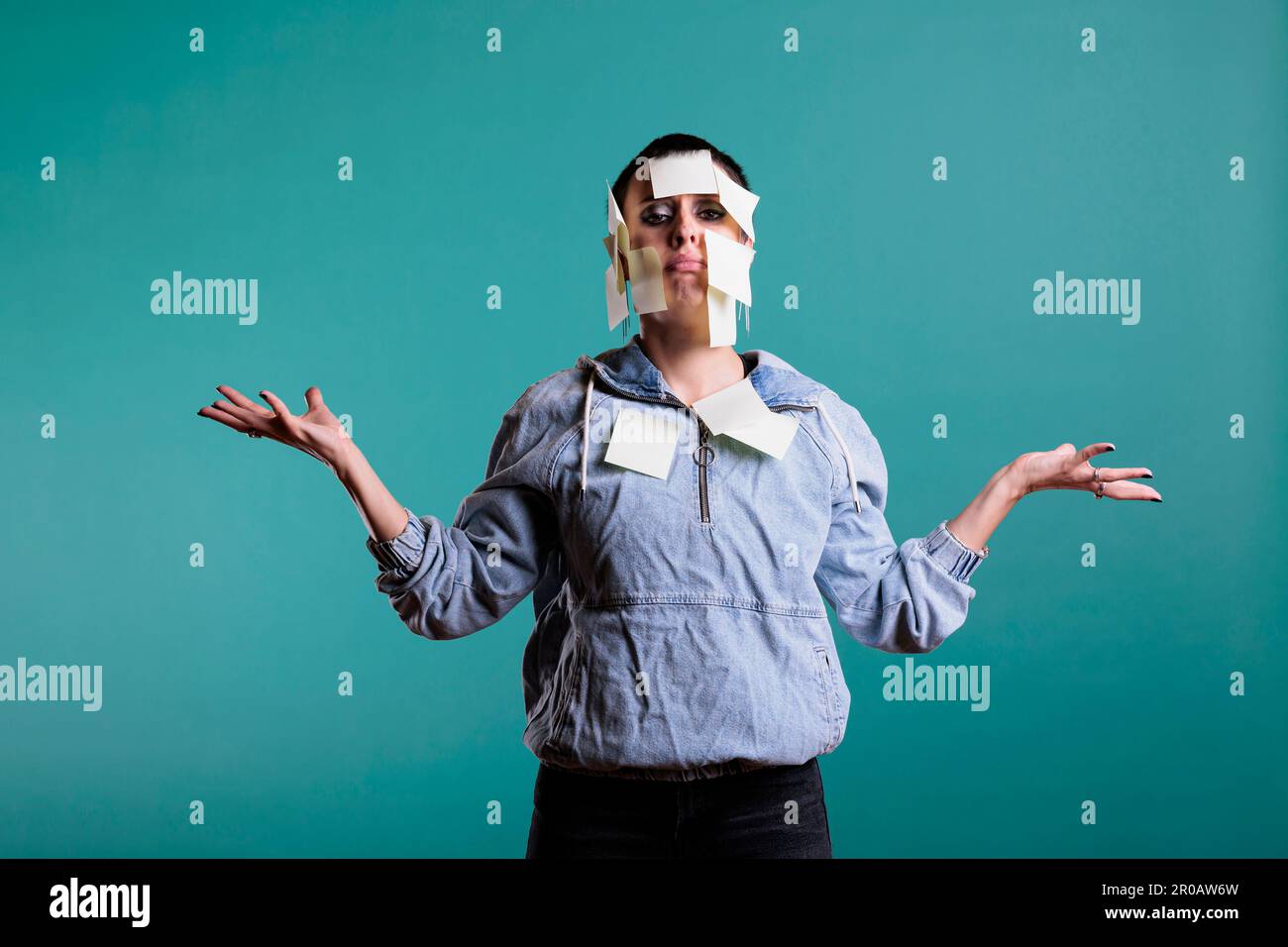 Tired overworked woman writes down memo messages using paper sticky ...