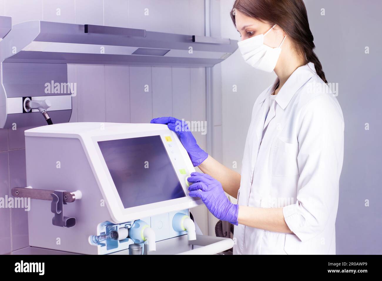 Young woman doctor adjusts the oxygen supply apparatus. Resuscitation ...
