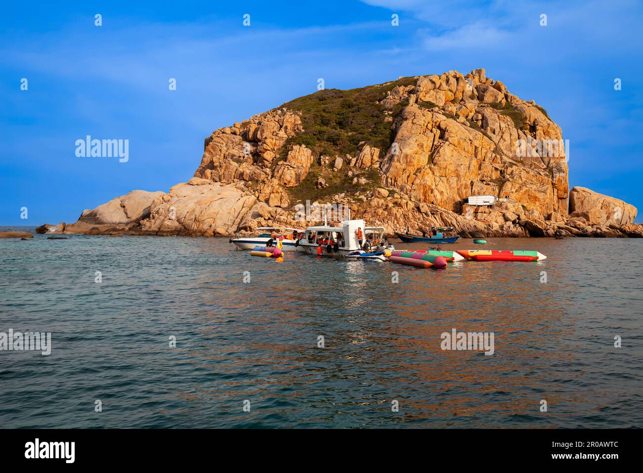Rocky coastal of island Hon Tai, in the Bay of Mui Ca Heo, Vinh Hy ...