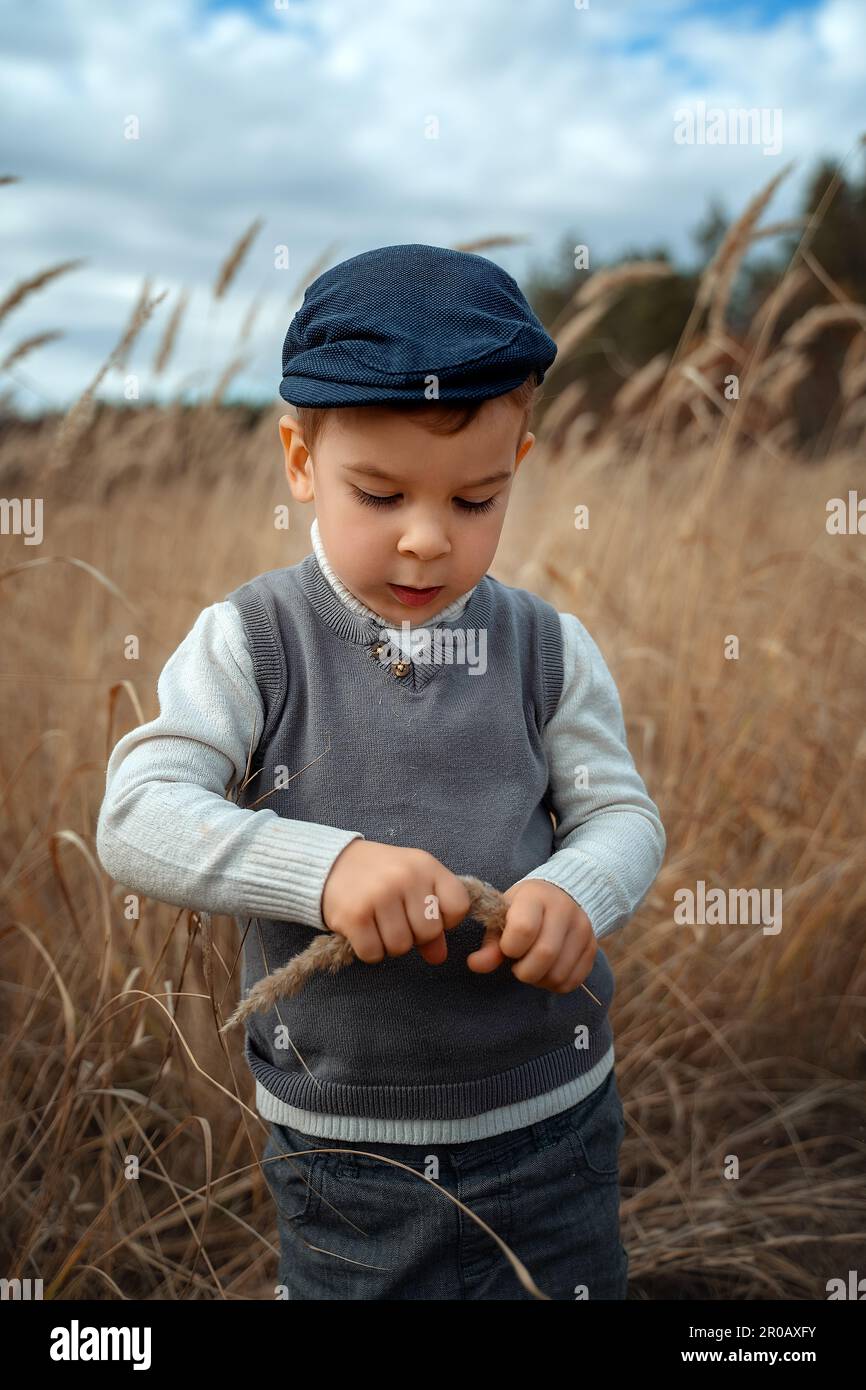 Children's fashion, retro style. A smiling little boy in a retro style ...