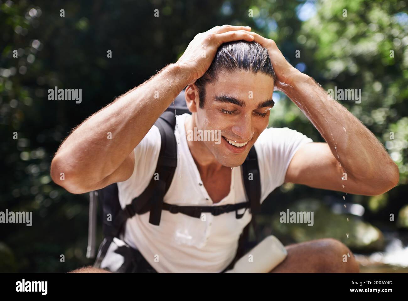 Feeling completely refreshed. A young man stopping for a break while ...