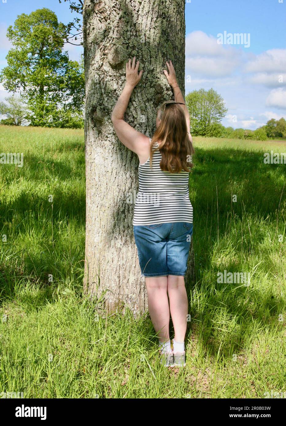 A lady tree hugger in the French countryside Stock Photo - Alamy
