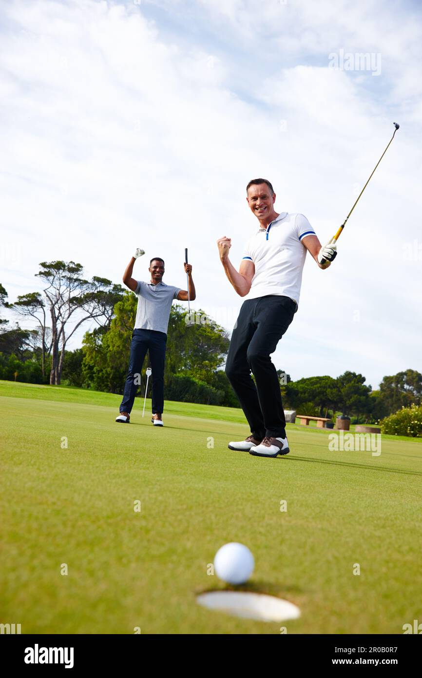 Just like the pros. Low angle shot of a golf ball approaching the hole ...