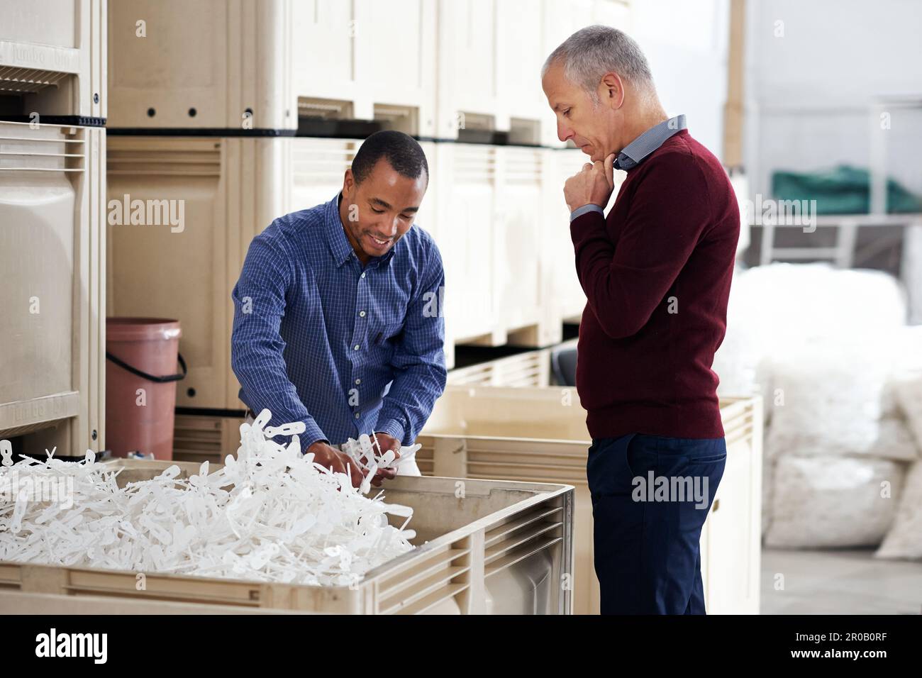 Inspecting product quality. two factory managers doing an inspection of ...