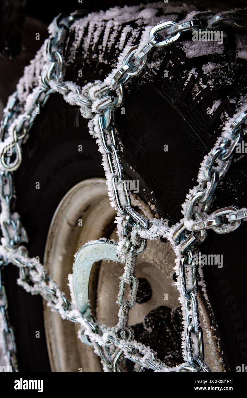 Close up. Winter chains of anti-skid on a motor-car wheel. Safe driving ...