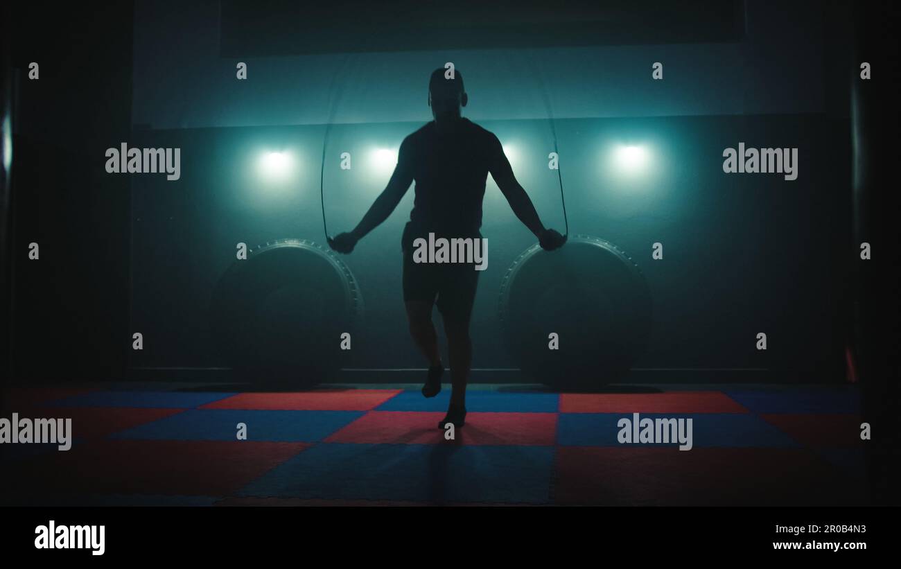 Man using a jumping rope to improve muscle strength Stock Photo - Alamy