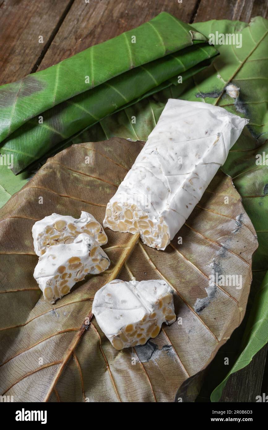 Raw tempeh or tempe. Tempe is fermented from soybeans wrapped with ...