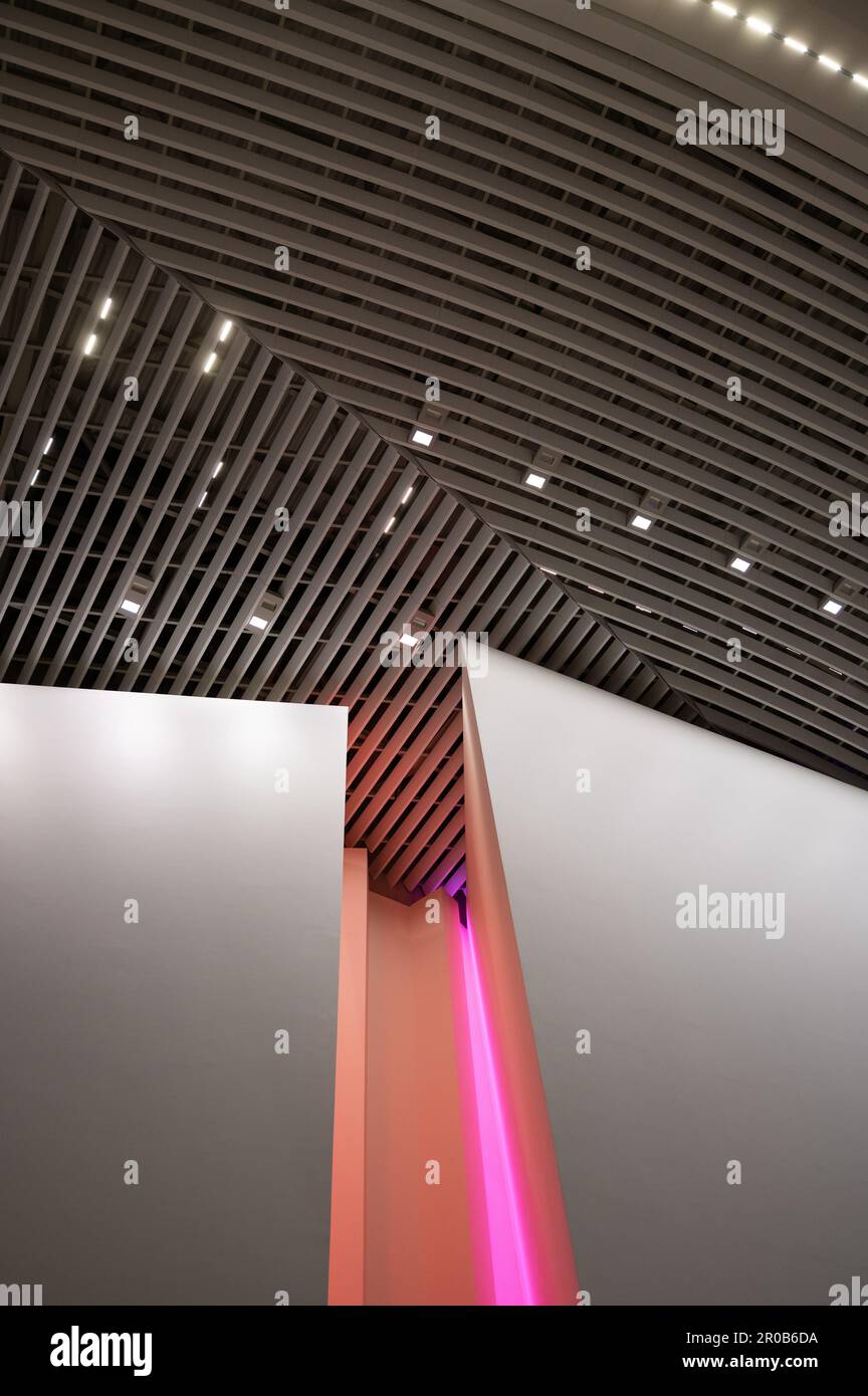 A modern interior of a building featuring a white ceiling with recessed ...