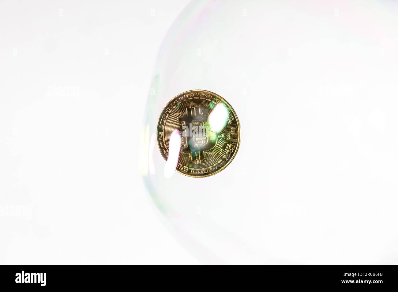 One gold bitcoin coin with white background inside a big bubble Stock ...
