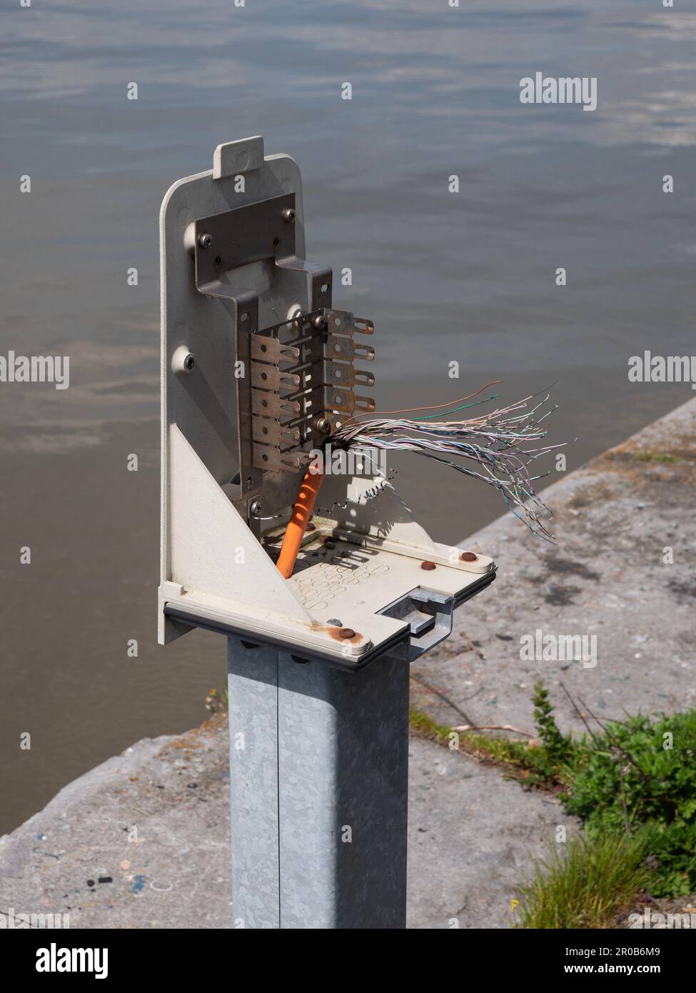 A broken pole of a barrier where the electricity wires are exposed on ...