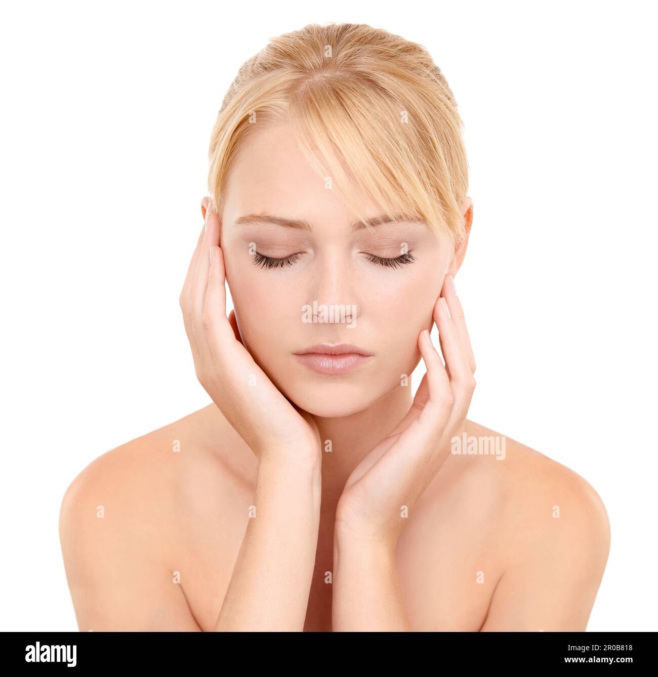 Softly caressing her skin. Studio shot of a young woman touching her ...