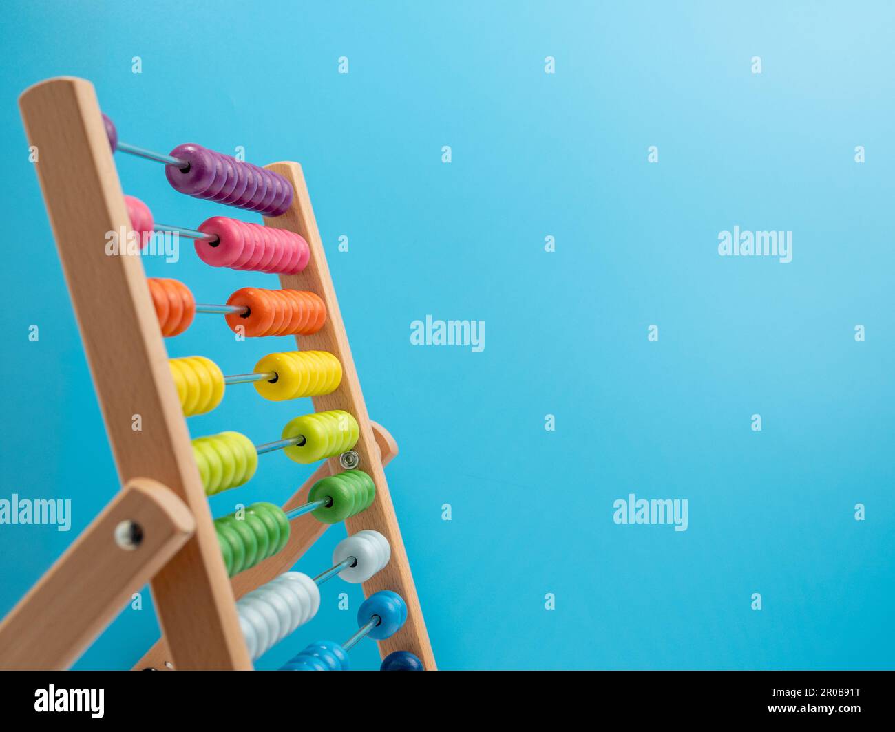Wooden abacus on a blue background, Wooden abacus for children. Wooden ...