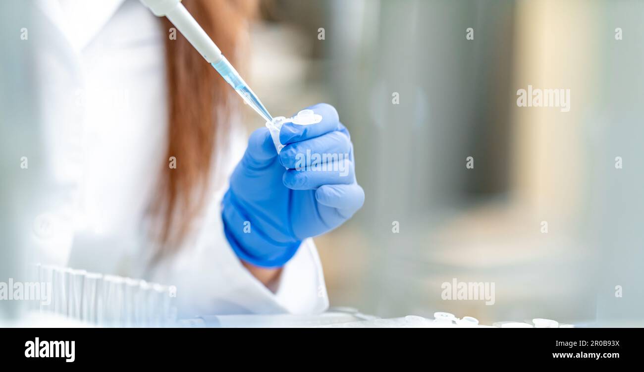 pipetting a chemical sample into research glass flasks Stock Photo - Alamy