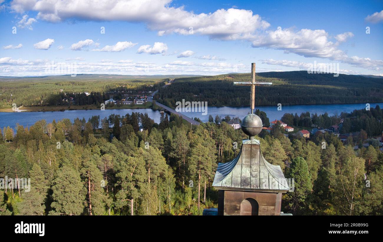 An aerial view of a clock tower in a picturesque wooded area ...