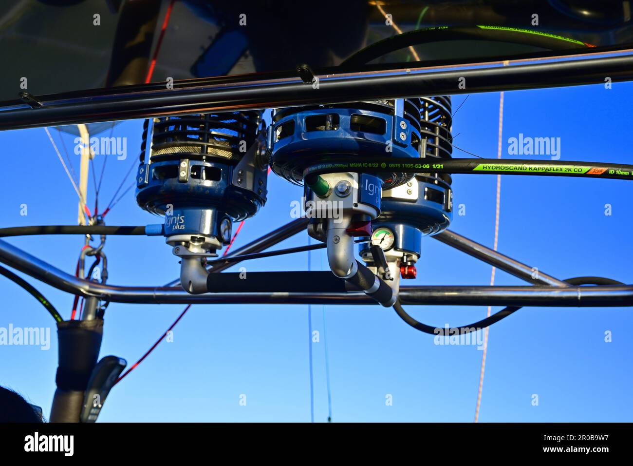 Two metallic cables attached to a silver metallic frame against a ...