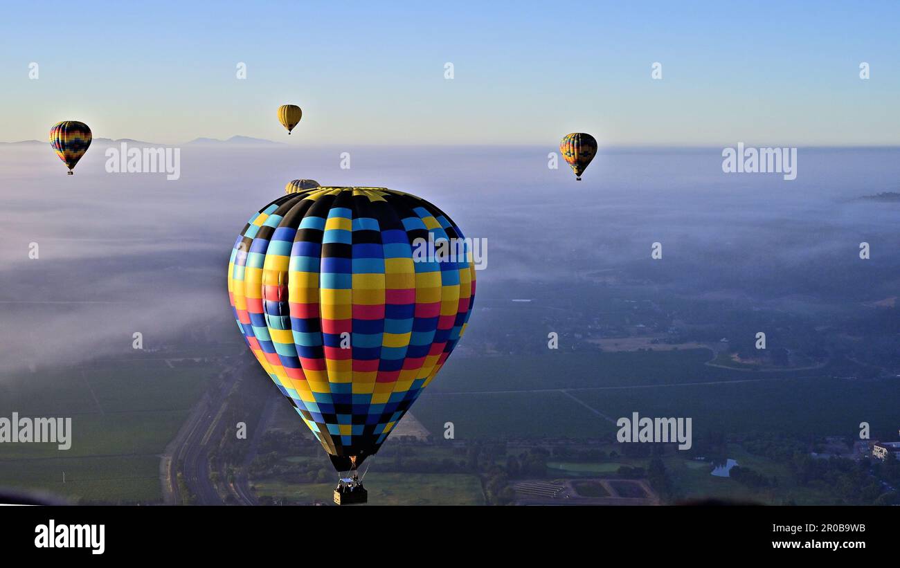 An aerial view of a stunning array of brightly colored hot air balloons ...