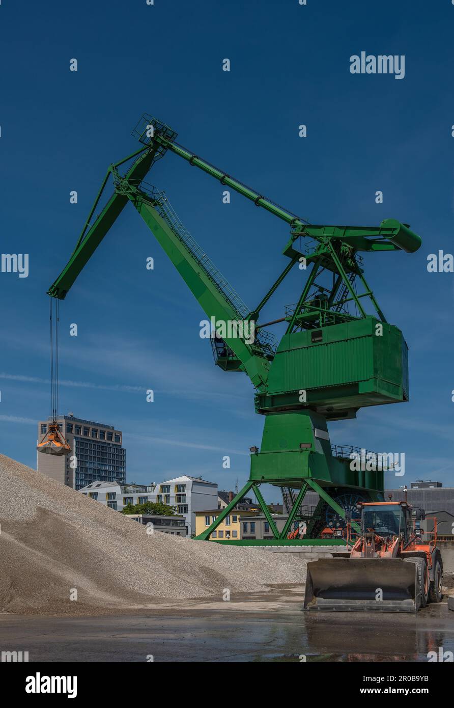 Exterior view of a cement factory with green crane Stock Photo - Alamy