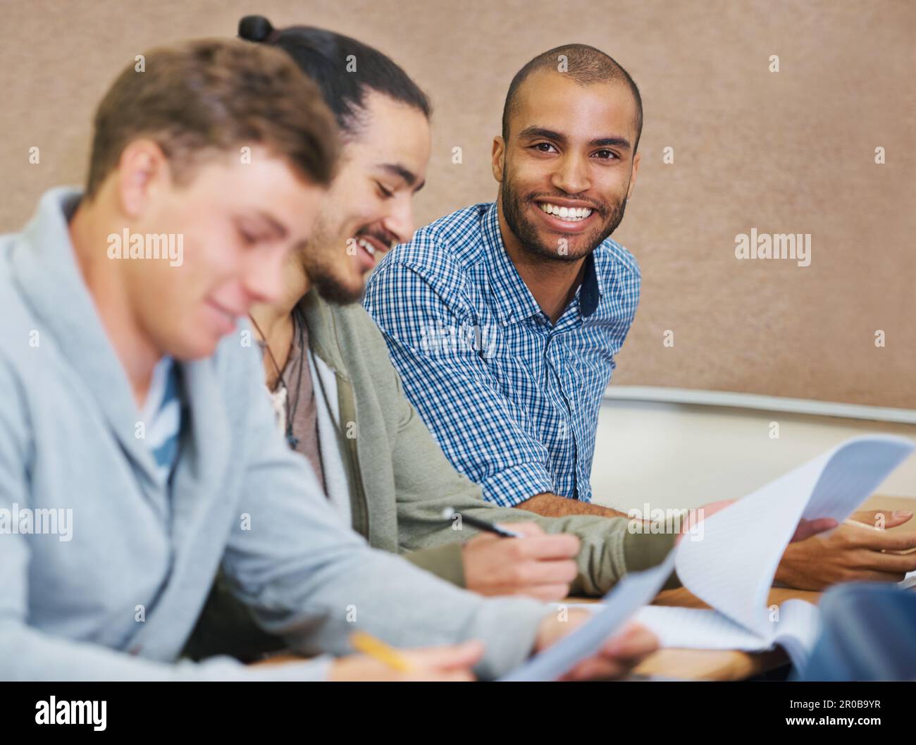 Class is in session. university students in a classroom Stock Photo - Alamy