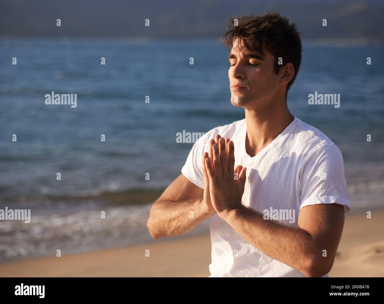 Finding balance on the beach. a young man doing yoga at the beach Stock ...