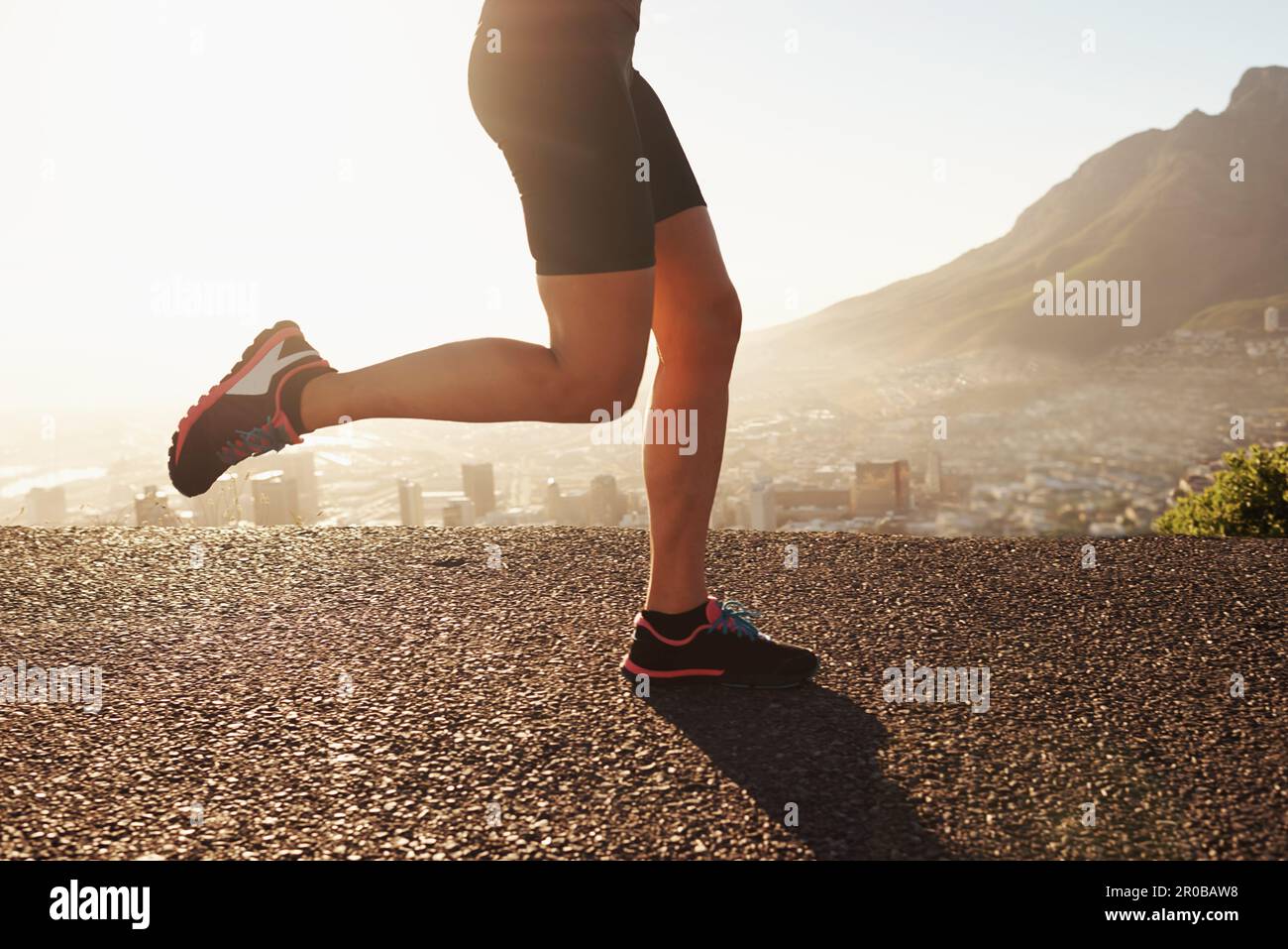 Get your body moving. an athlete running along a road Stock Photo - Alamy