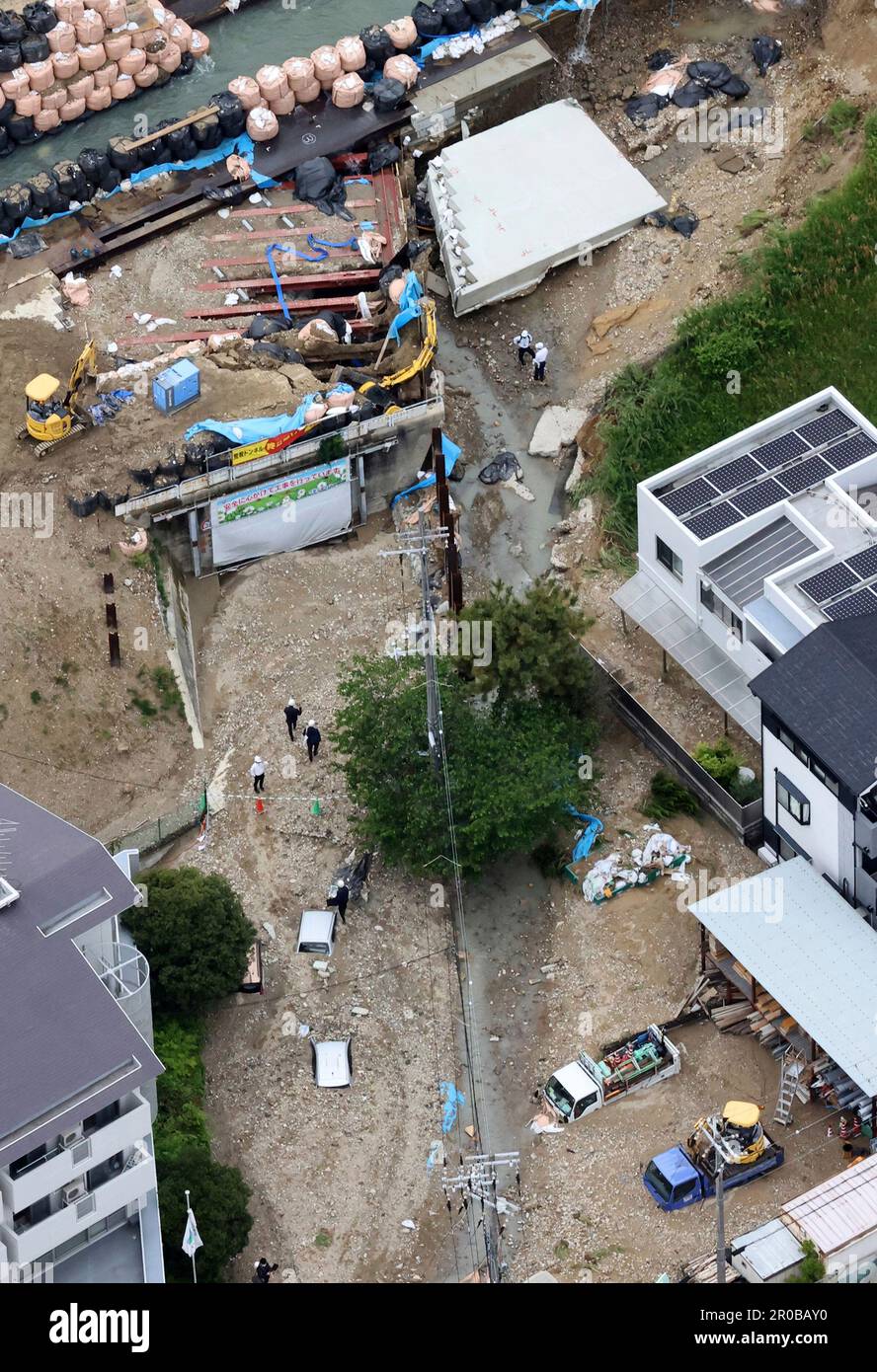 An aerial photo shows vehicles buried in a mudslide due to the ...