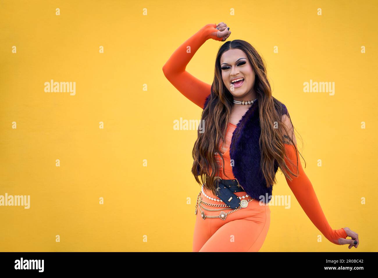 Portrait of excited transgender young with yellow background. Fun Drag ...