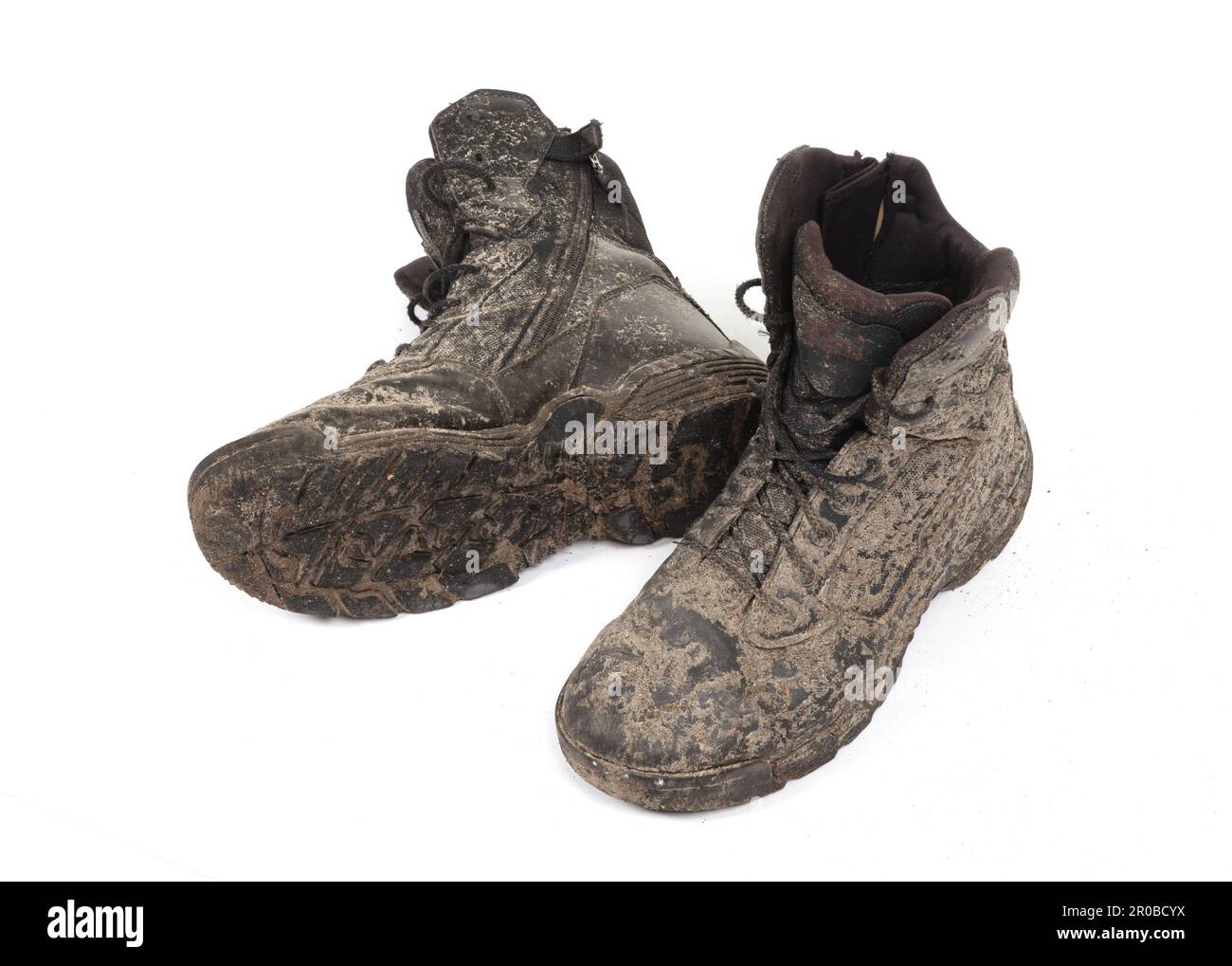Black shoes, covered in mud, isolated on white Stock Photo - Alamy