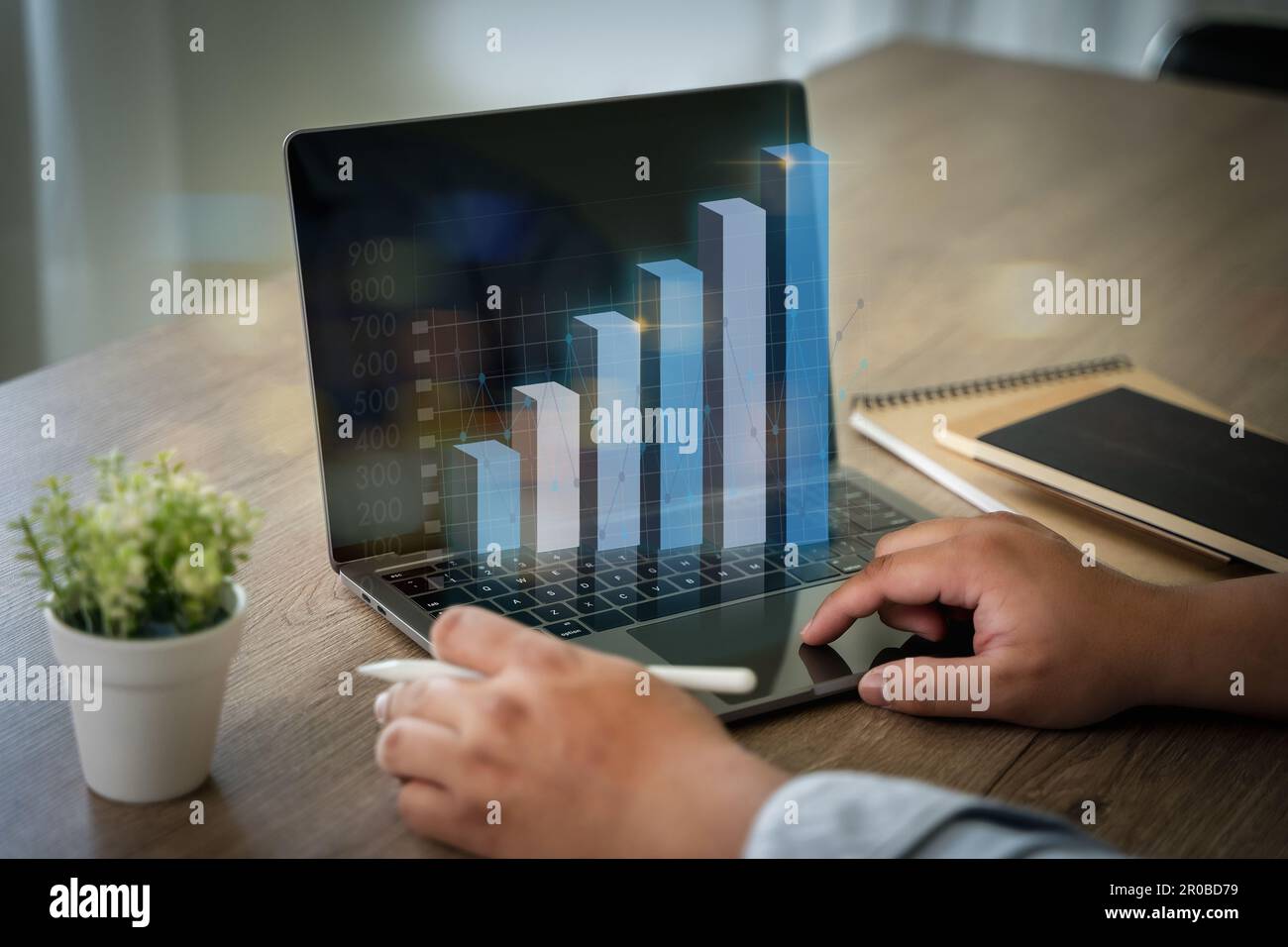 A businessman draws a growth graph showing the success of business ...