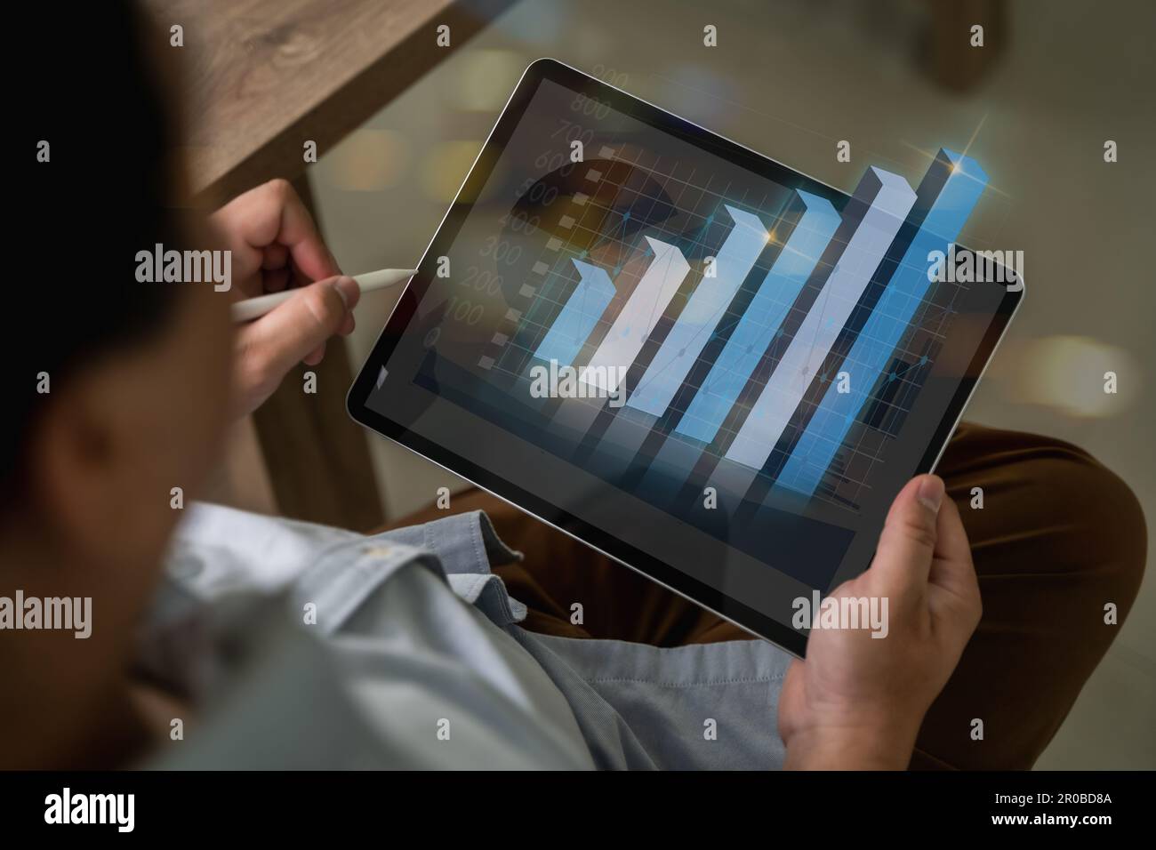 A businessman draws a growth graph showing the success of business ...