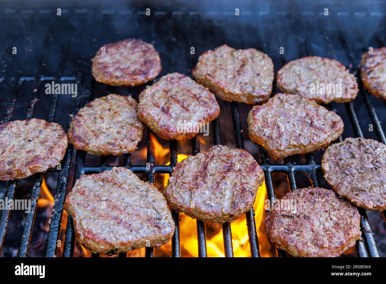 Grilled american beef burger barbecue on hot grill on flame Stock Photo ...
