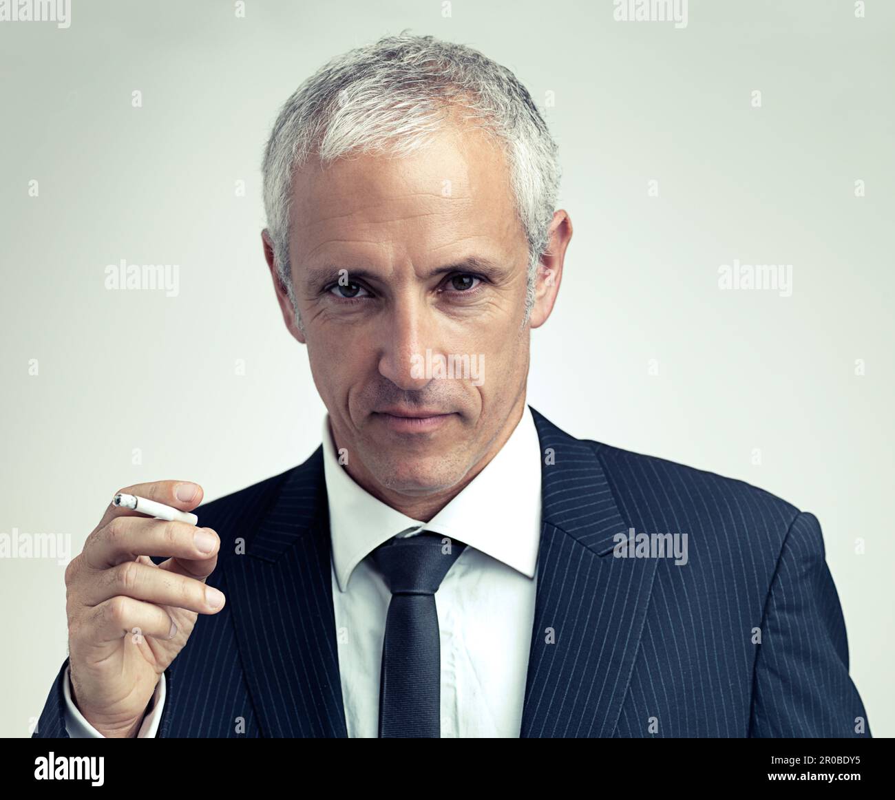 Smoking suits him. A cropped portrait of a serious mature man in a ...