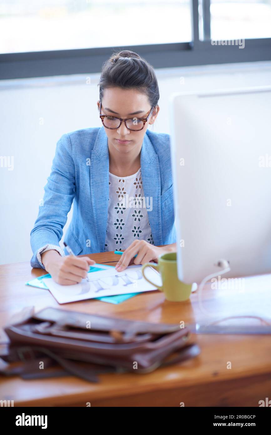 Long hours pay off in the end. Young professional woman working ...