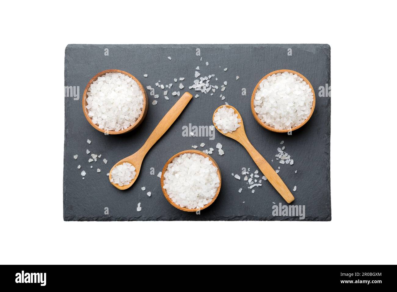 A wooden bowl of salt crystals isolated on white background. Salt in ...