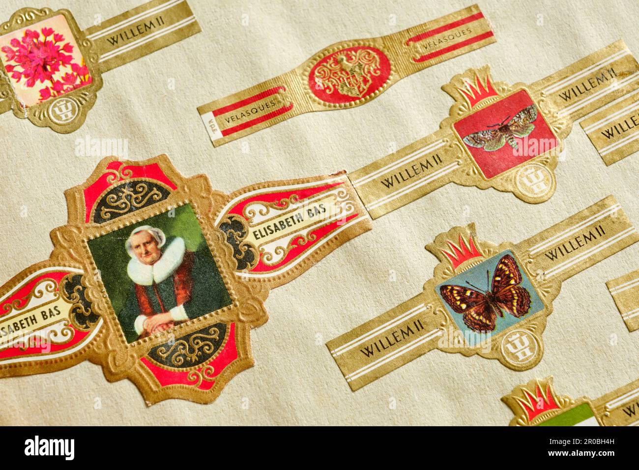 A collection of cigar bands in an old retro scrapbook with dutch brands ...